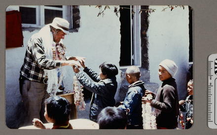 [Sir Edmund Hillary accepting garland from child] - Collections Online ...