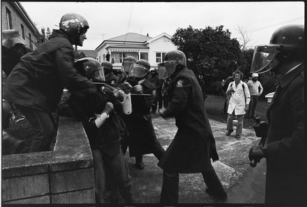 A Red Squad officer repeatedly strikes a woman anti-Tour protestor ...